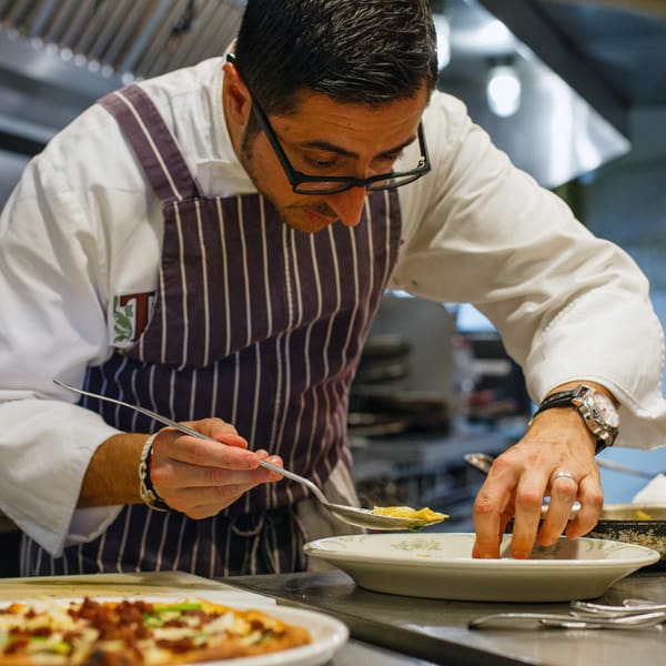 Chef Vincenzo Betulia plating pasta; Photography by Michael Caronchi